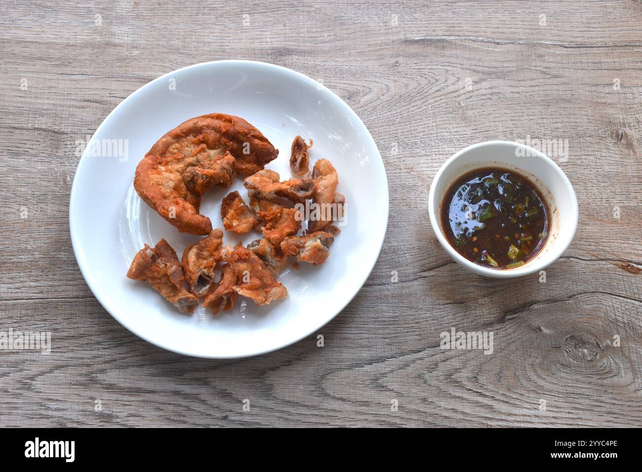 crispy fried pork innards with flour on plate dipping with spicy ...
