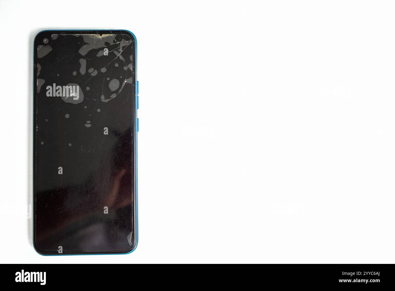 A smartphone with a visible cracked screen is set against a plain white ...