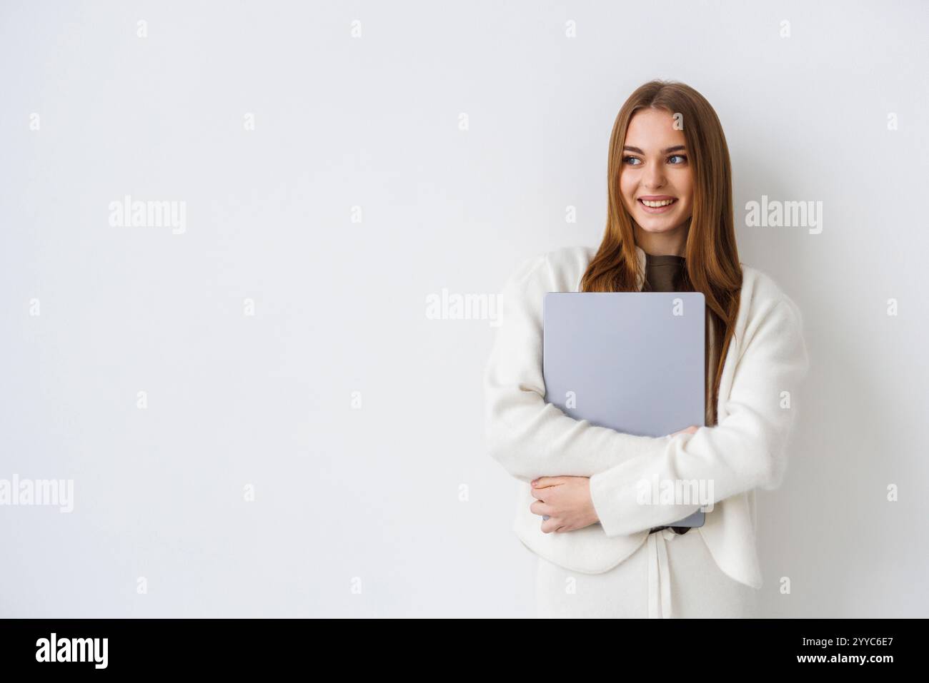 Portrait of a pretty girl standing isolated over white background ...