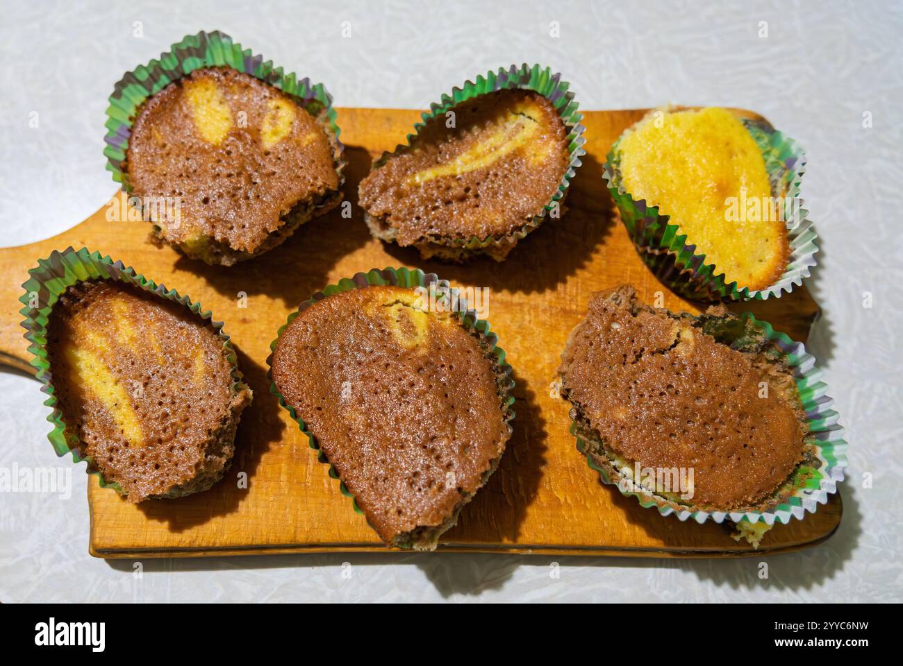 A selection of freshly baked sweet treats is displayed on a wooden ...