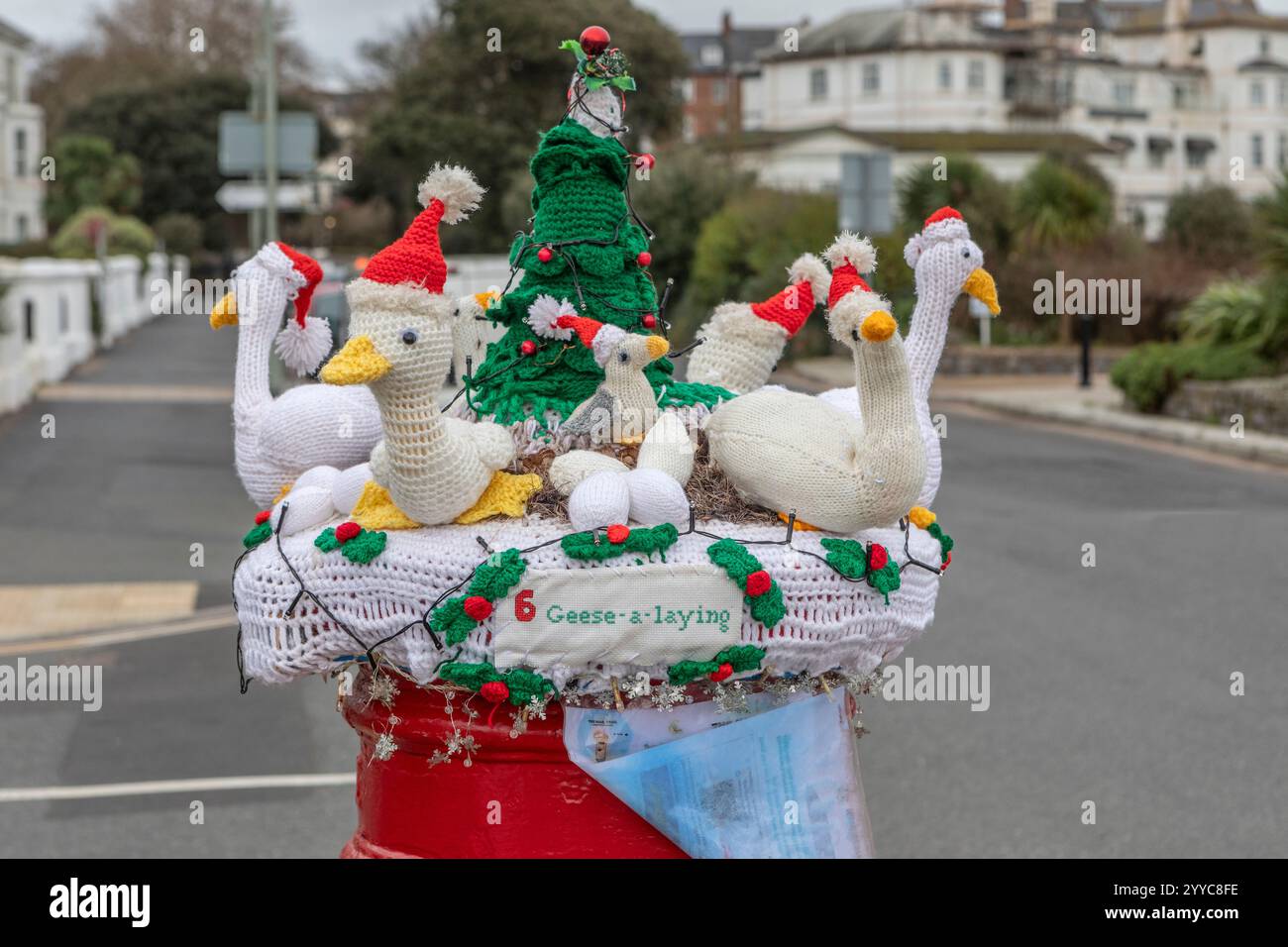 A knitted letter box decoration of six geese a laying in Exmouth, Devon ...