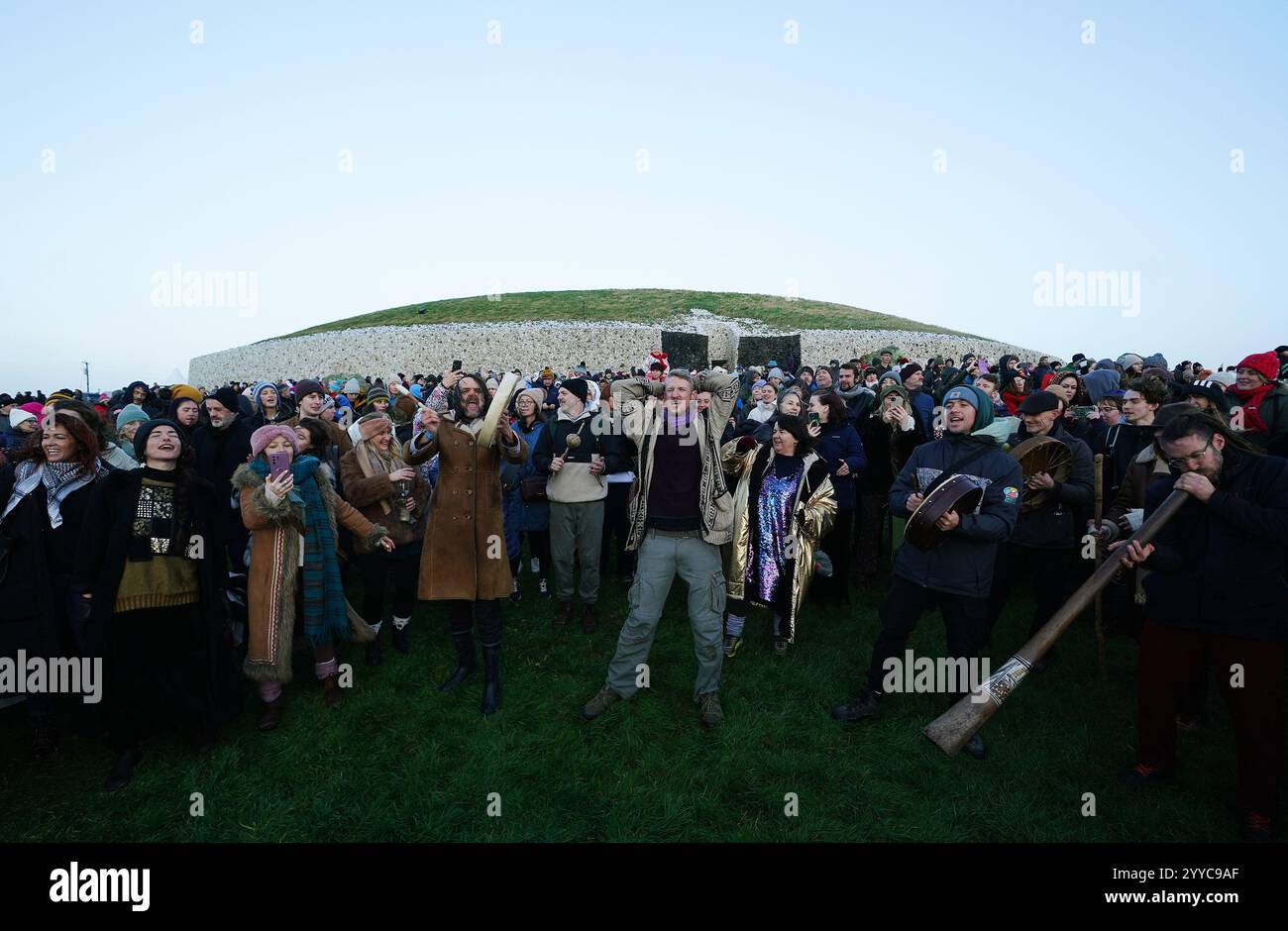 People celebrate the sun rising as they gather at Newgrange, Co. Meath ...