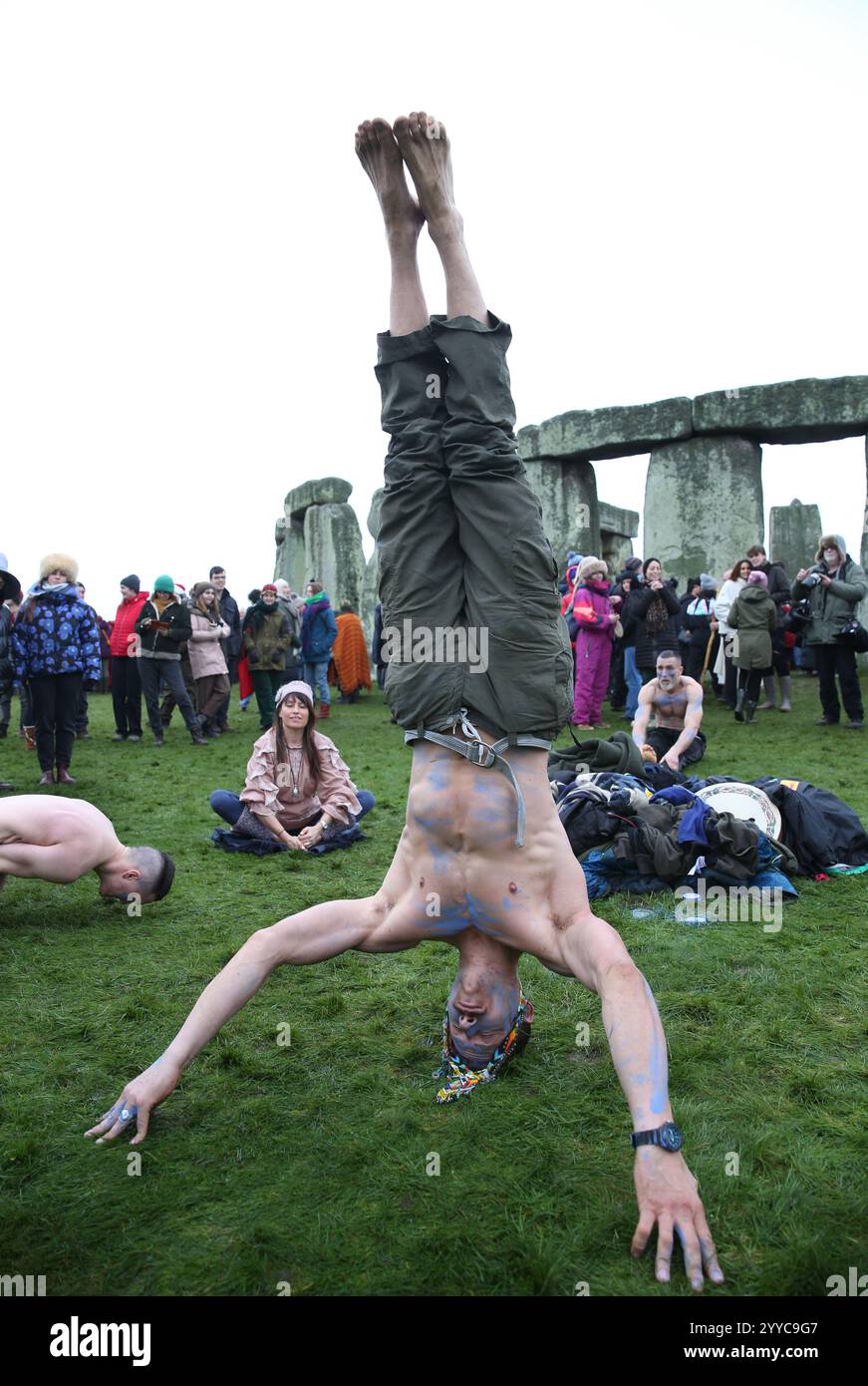 December 21, 2024, Salisbury, England, UK: In the shadow of the stones ...
