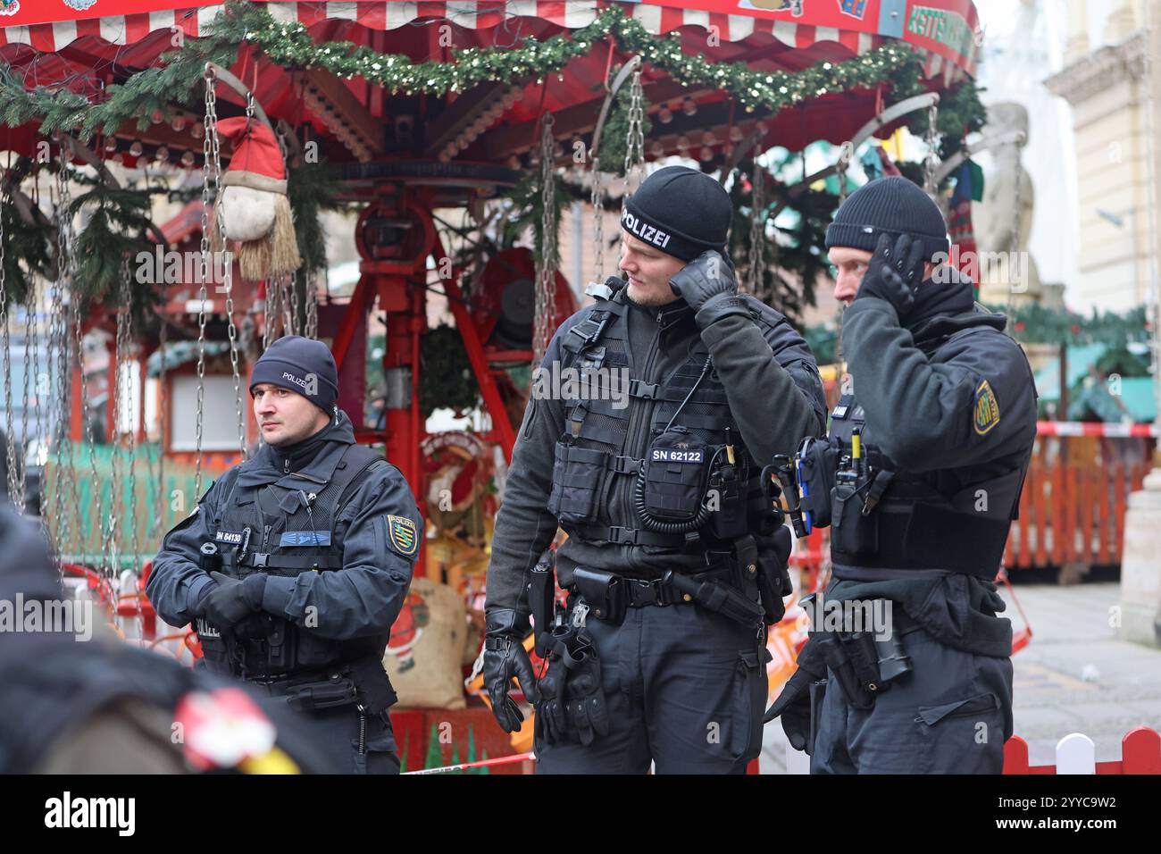 Magdeburg, Germany. 21st Dec, 2024. Police officers stand in front of a ...
