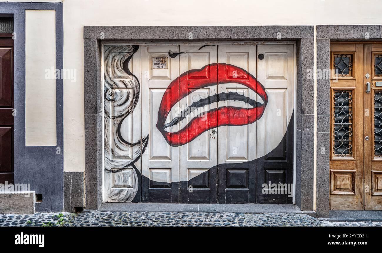 Unique and colorful street art featuring bold red lips painted on a ...