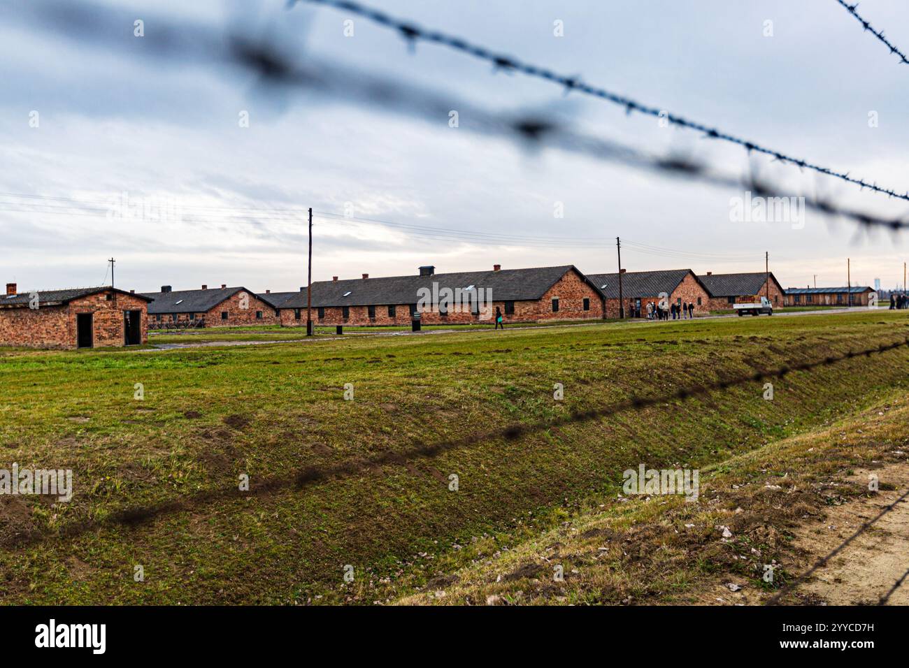 Brick Barracks Seen Through Barbed Wire at Auschwitz-Birkenau Stock ...