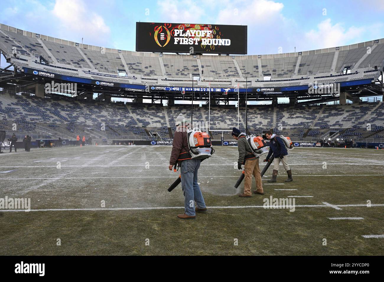 Penn State grounds crew members clear the snow from the field at Beaver ...