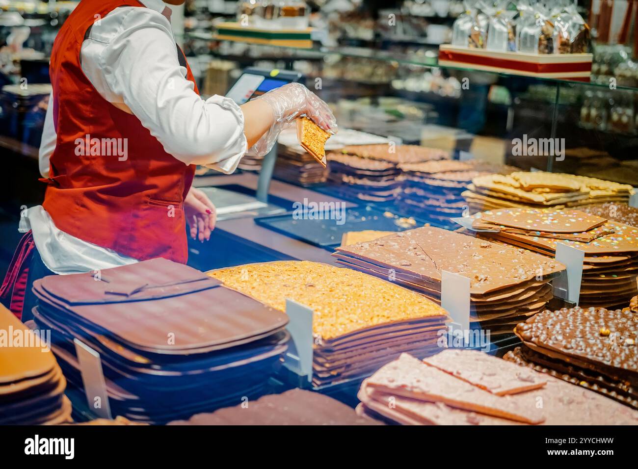 Small business owner woman with large chocolate bars in her store Stock ...