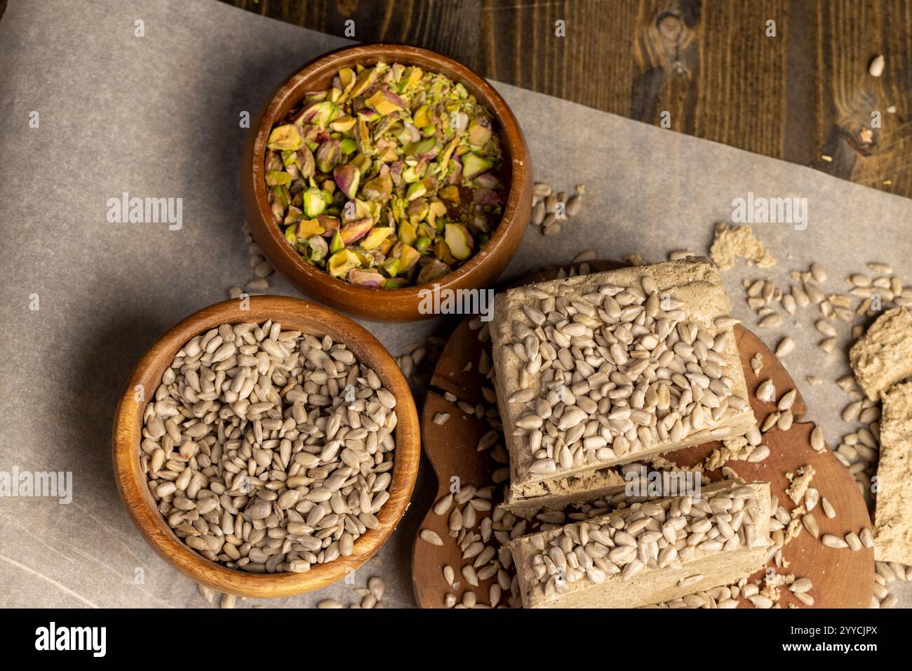 cut halva from sunflower seeds and crushed into one solid mass with pistachios in a wooden bowl ...