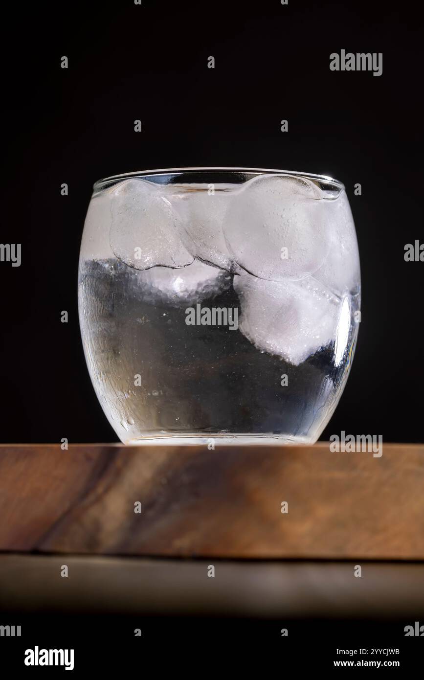 glass with cold sparkling water closeup, cold mineral water with a lot of gases and bubbles ...