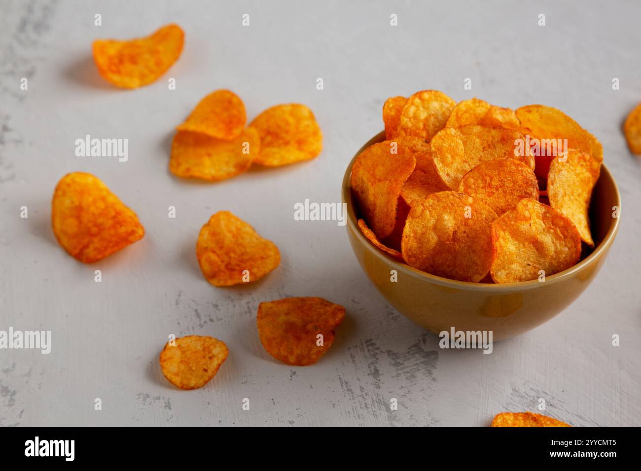 Homemade Flavored Paprika Potato Chips in a Bowl, side view Stock Photo ...
