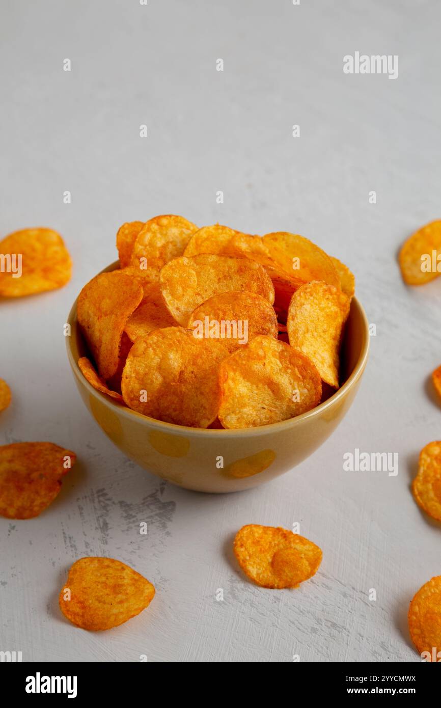 Homemade Flavored Paprika Potato Chips in a Bowl, side view Stock Photo ...