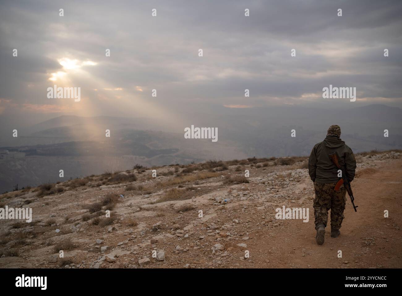 A Syrian fighter walks on an area at the top of the mount Qasioun in ...