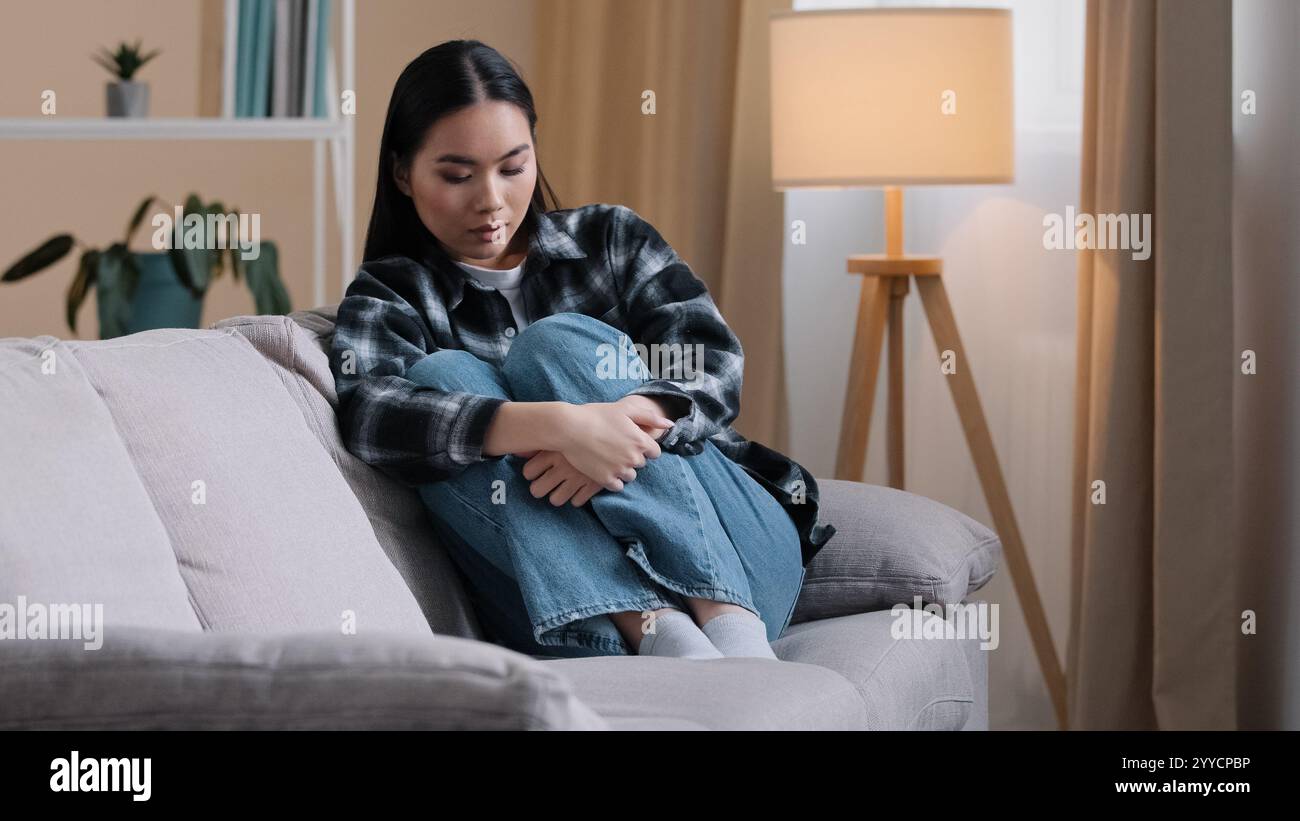 Sad worried asian korean woman having psychological problem sitting on ...