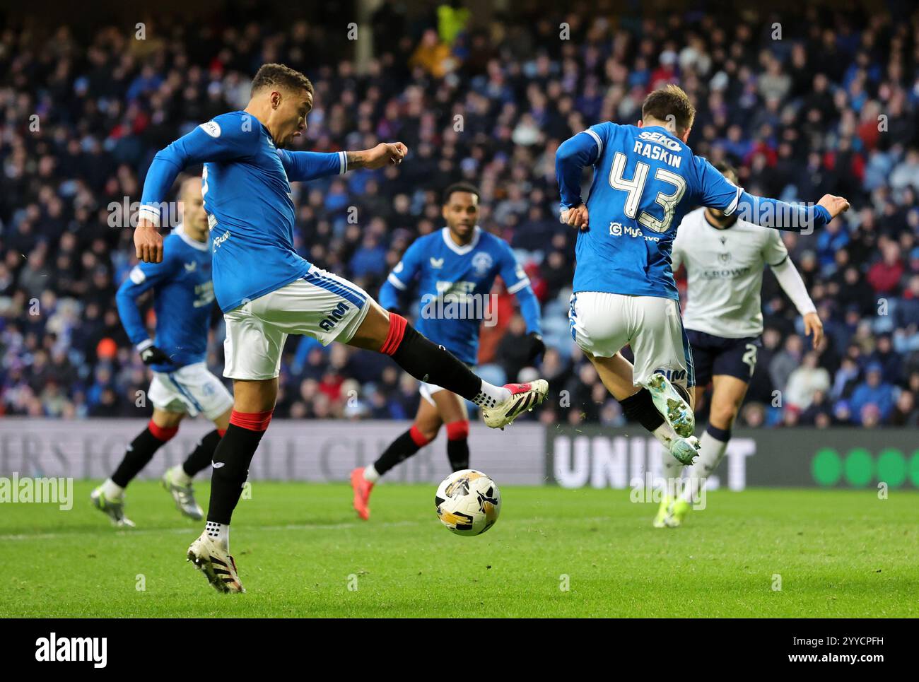 Rangers' James Tavernier (left) is impeded by team-mate Nicolas Raskin ...