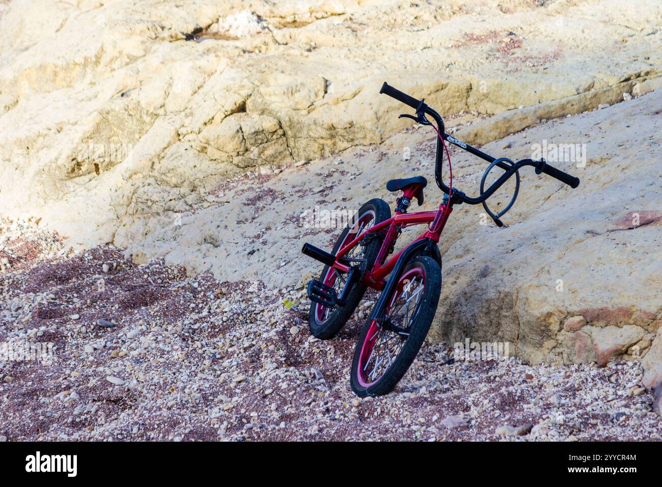 Red BMX Bike Parked on Rocky Terrain Under Bright Sunlight Stock Photo ...