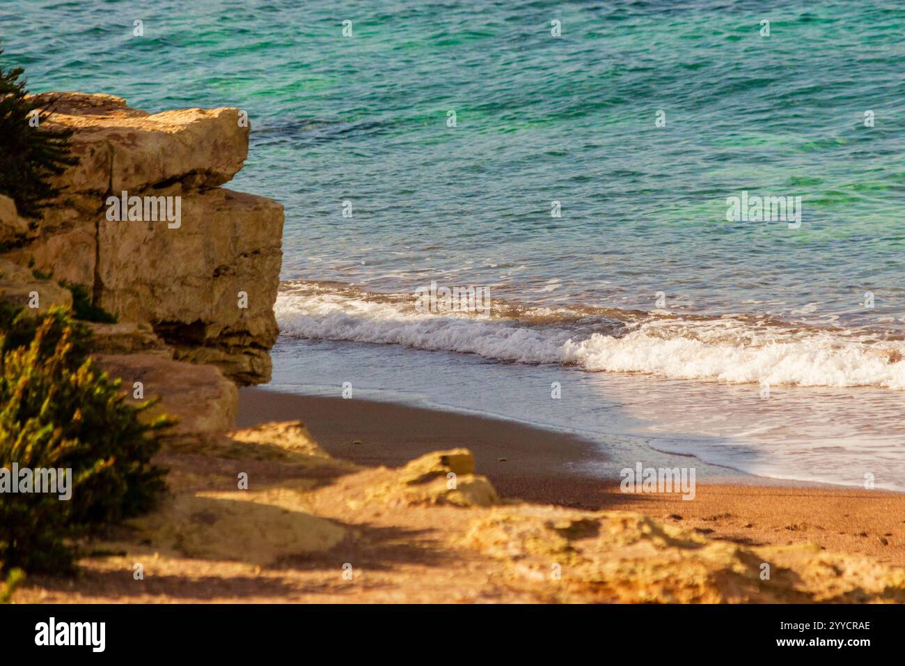 An idyllic scene of clear turquoise waters, gentle waves meeting sandy ...