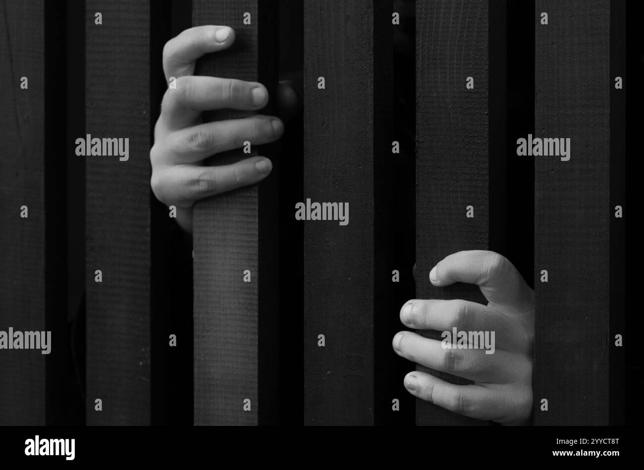Behind Bars: Framed Perspective of an Unknown Man Stock Photo - Alamy