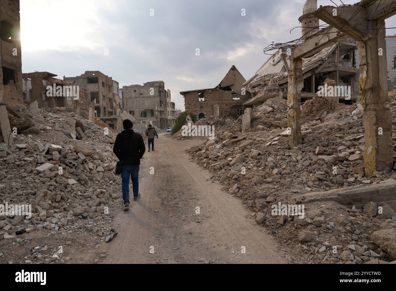 Syrians observe their houses in the neighbourhood of Jobar, in Damascus ...