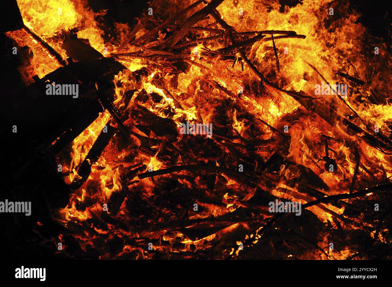 Hot fire catches pieces of wood, sparks fly around, campfire, Easter ...