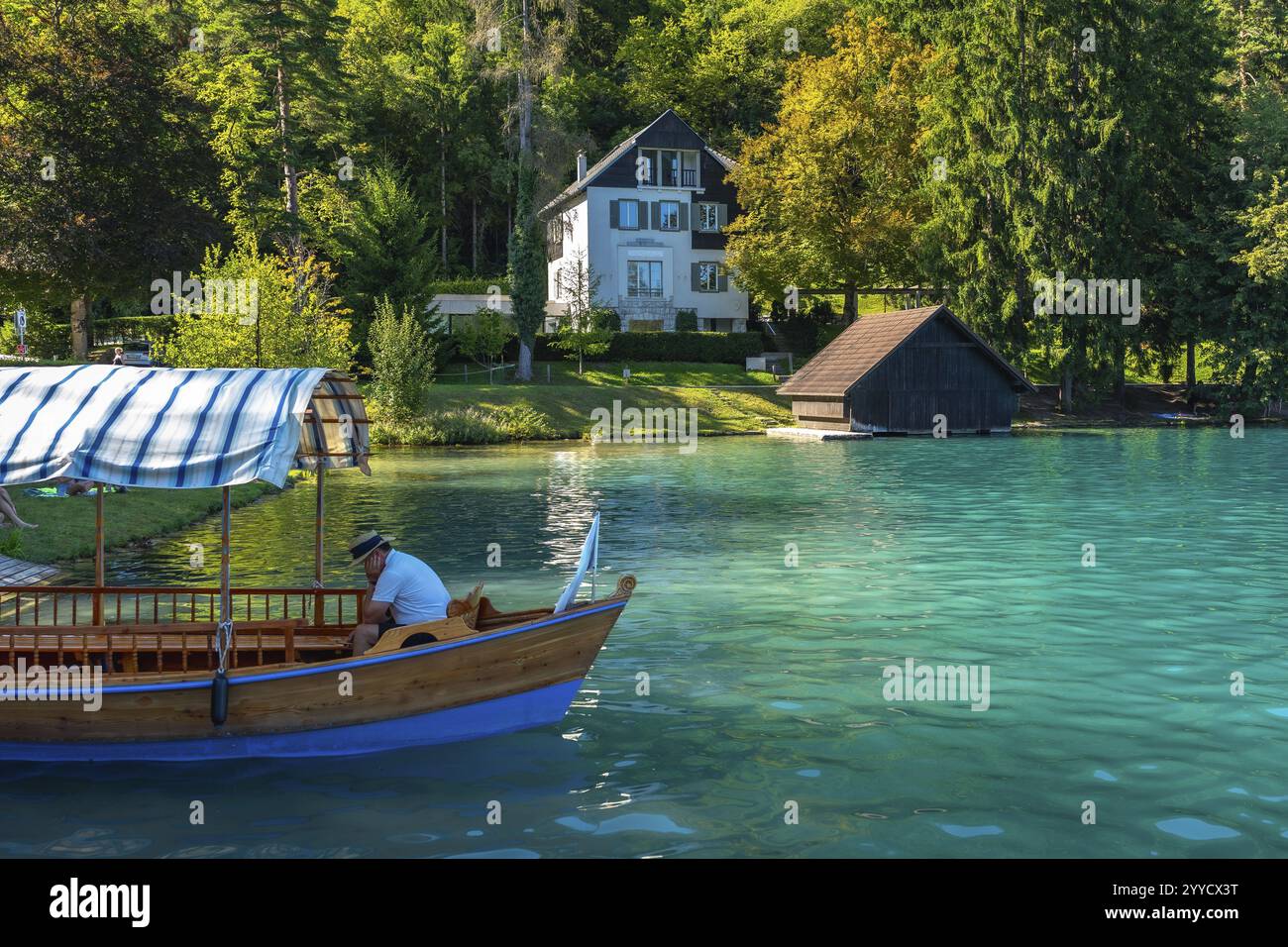 Traditional pletna boat waiting for tourists on the beautiful lake bled ...