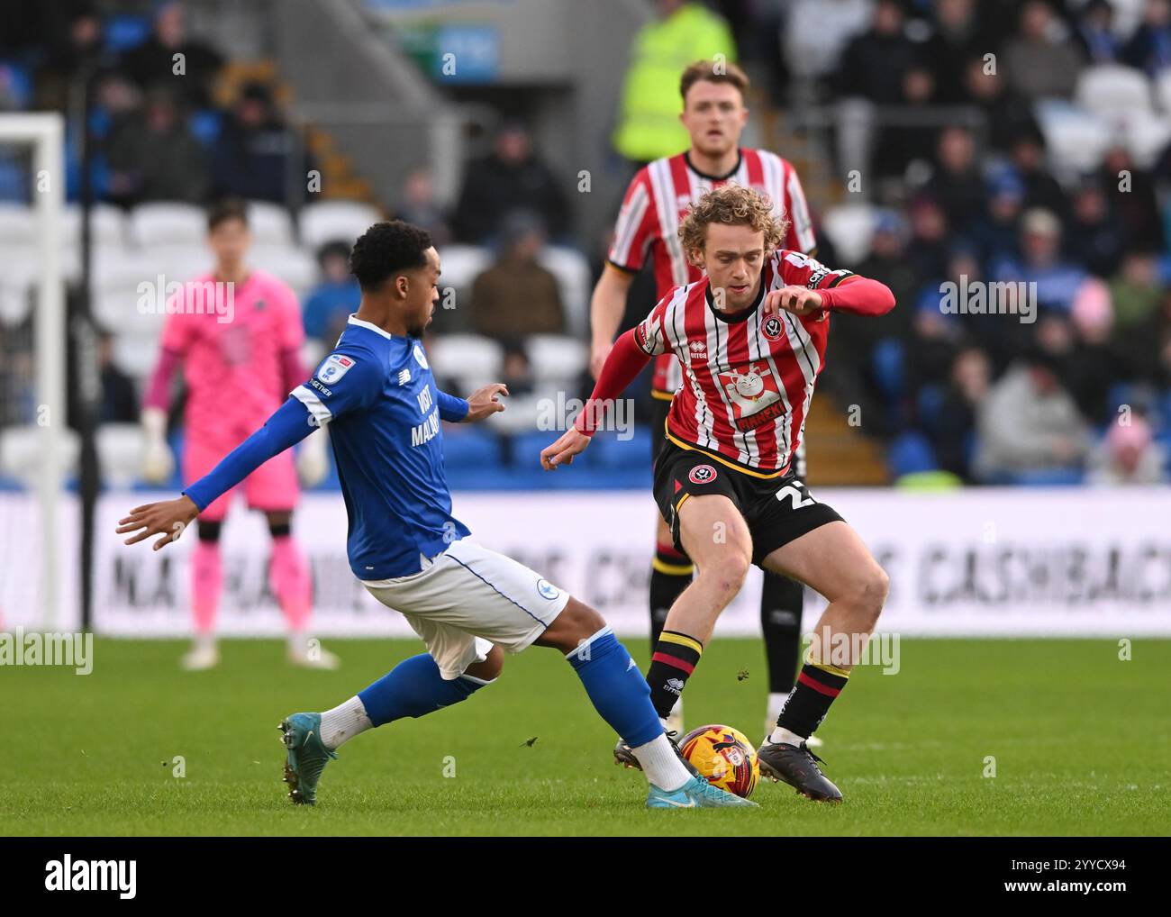 Birmingham, UK. 21st Dec, 2024. Chris Willock of Cardiff City tussles with Tom Davies of ...