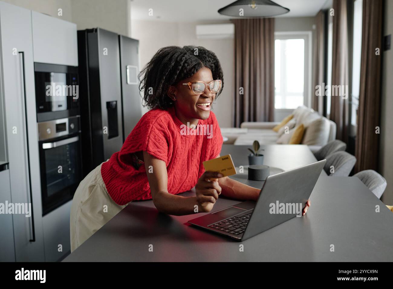African American beaming woman leaning on bar counter looking at ...
