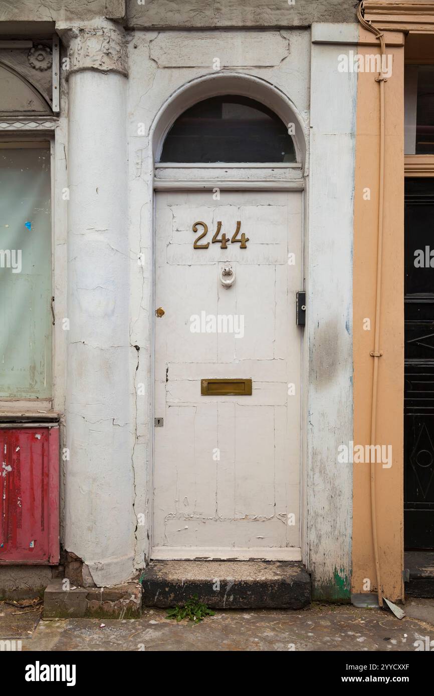 A door painted white with the number 244 on a street in London, England ...