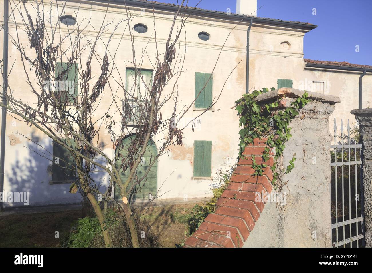Facade of an abandoned manor in a village in the italian countryside ...