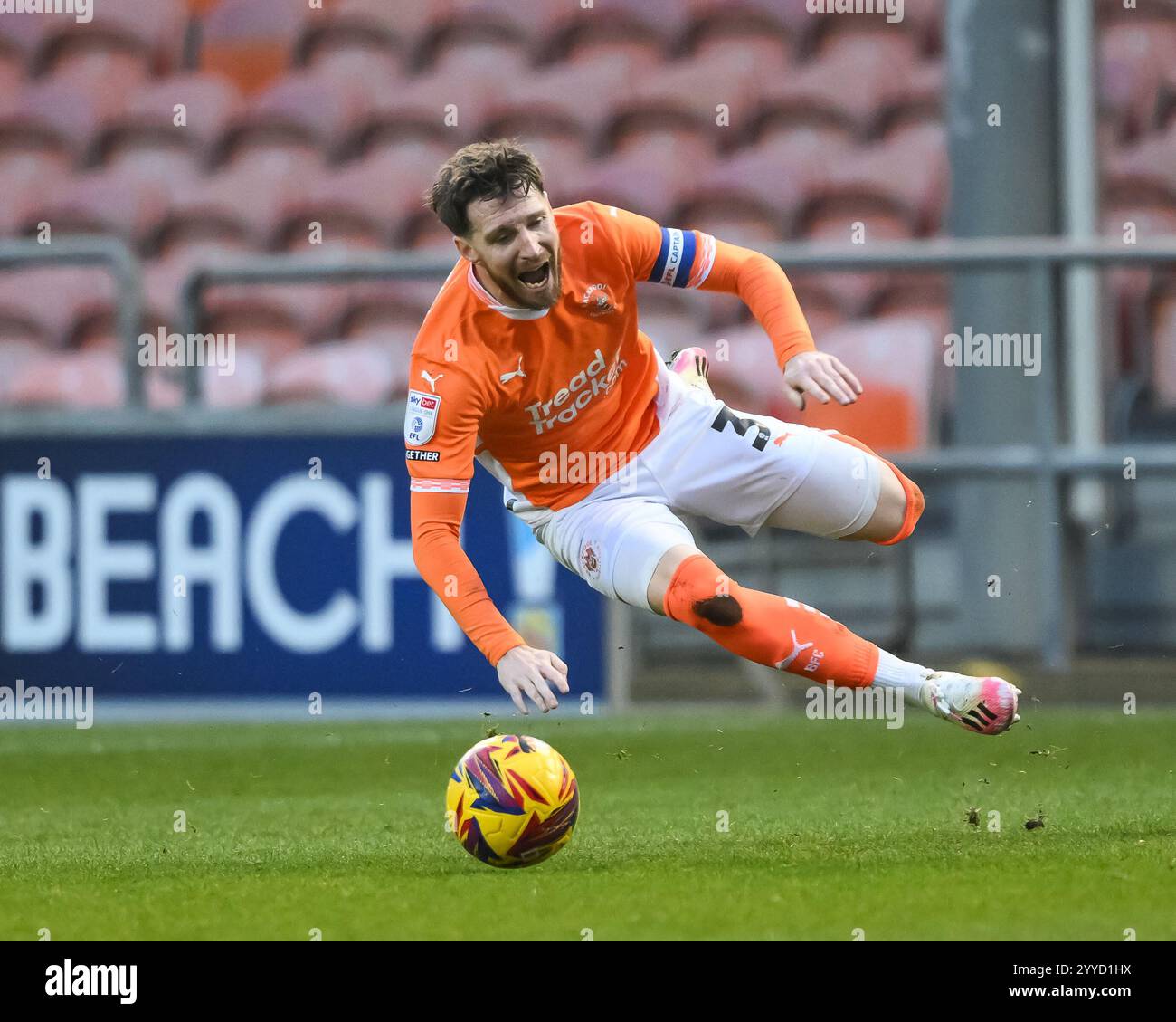 James Husband of Blackpool is fouled by Louis Thompson of Stevenage ...