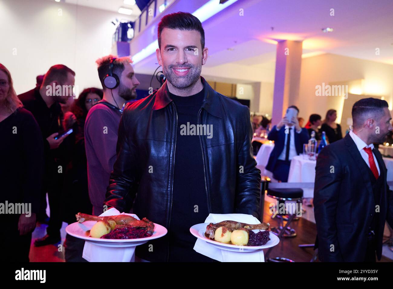 Berlin, Germany. 21st Dec, 2024. Jay Khan serves roast goose to needy ...