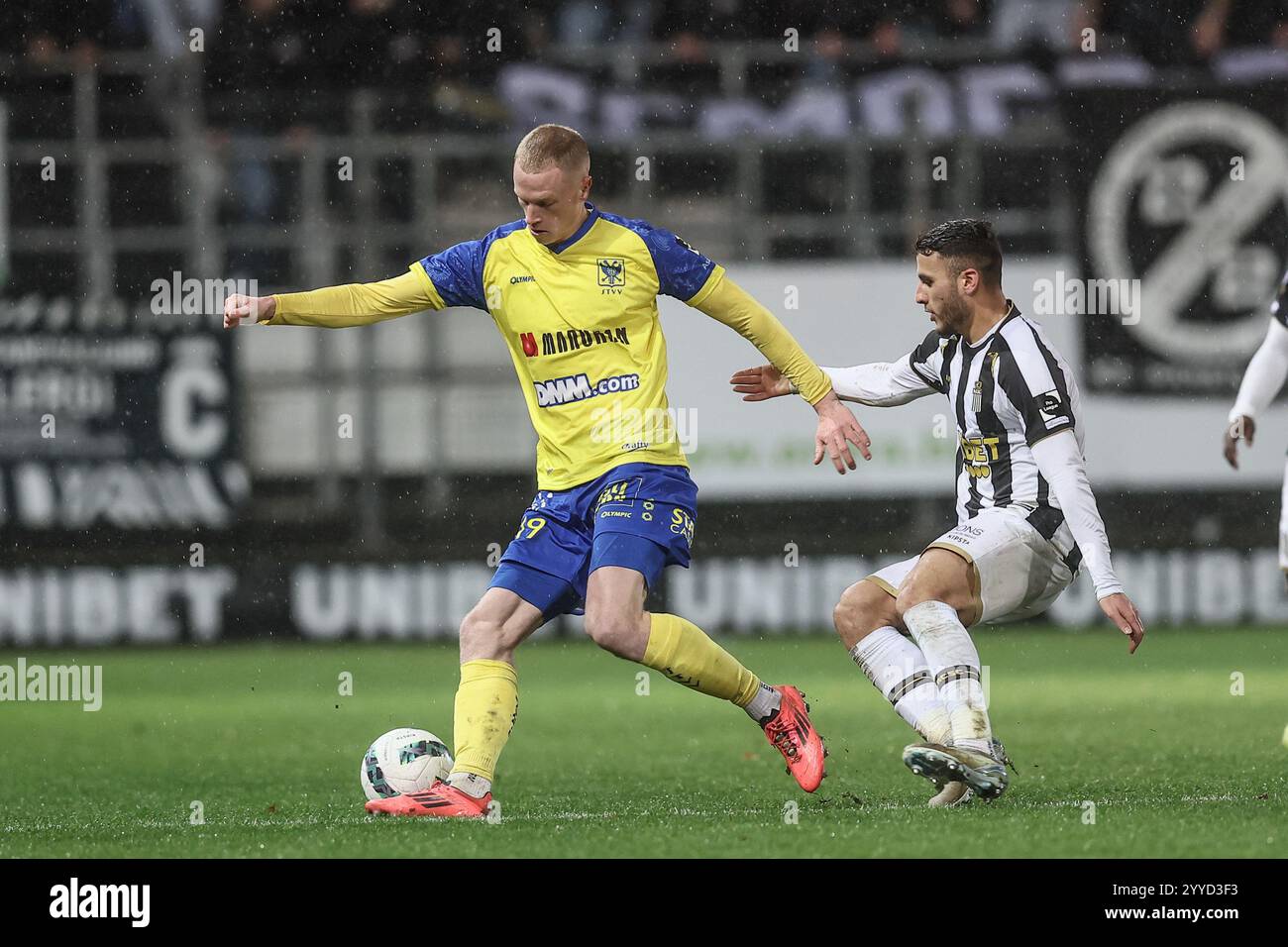 Sint Truiden, Belgium. 21st Dec, 2024. STVV's Louis Patris and Charleroi's Yacine Titraoui fight ...