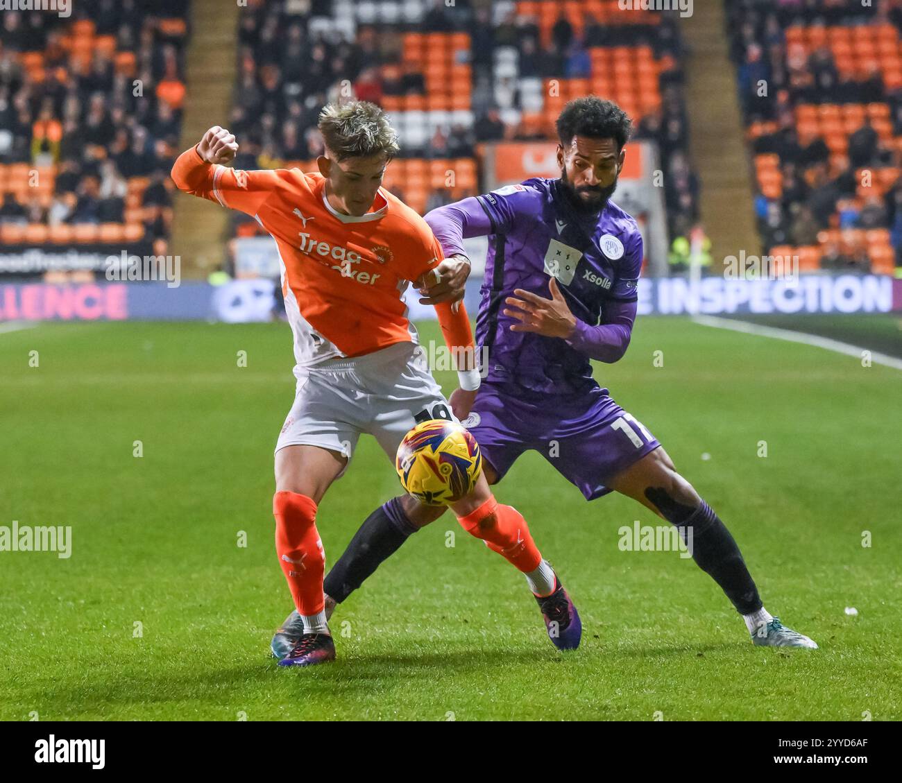 Dom Ballard of Blackpool and Jordan Roberts of Stevenage battle for the ...