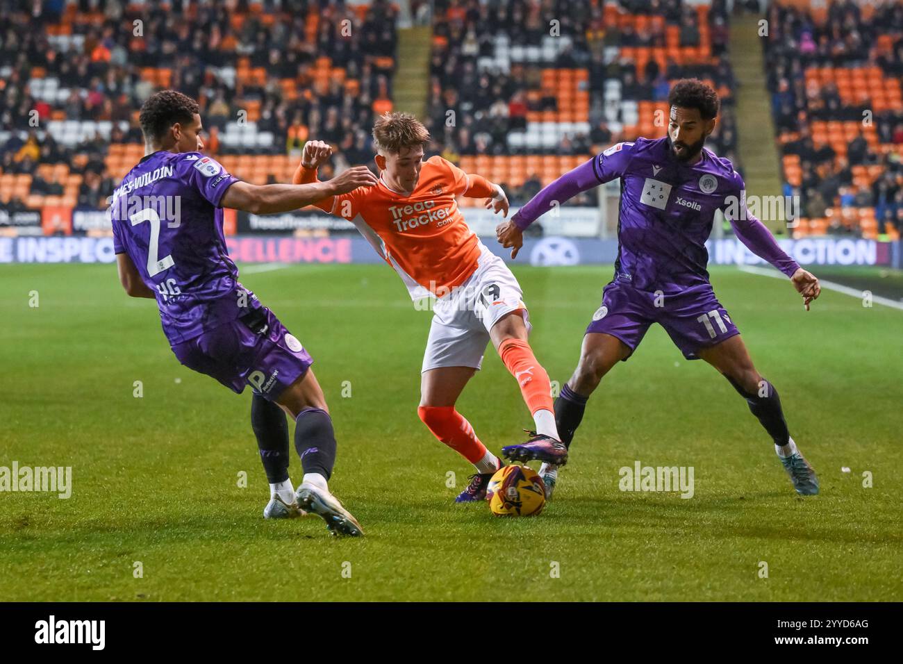 Dom Ballard of Blackpool and Jordan Roberts of Stevenage battle for the ...
