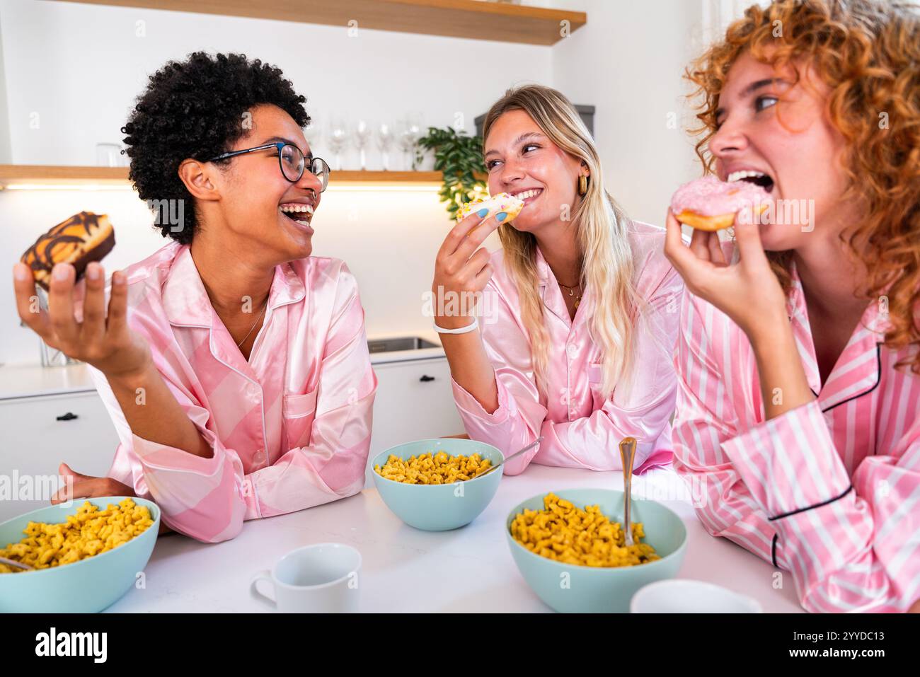 Multiethnic group of young female friends having breakfast during ...
