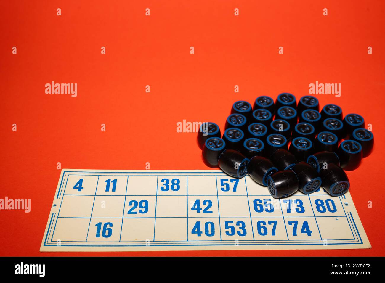 A vibrant orange background showcases a collection of black bingo ...