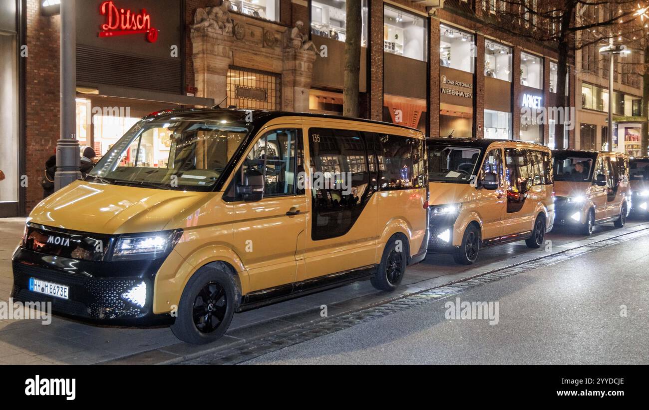 13 December 2024, Hamburg: Shuttle vehicles from the MOIA ridesharing ...