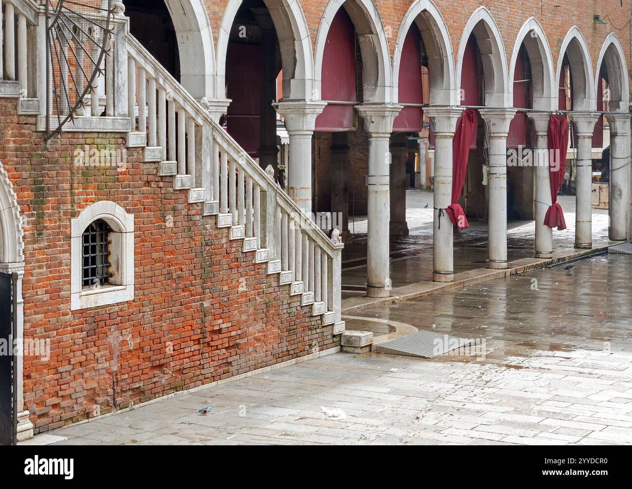 Wet floor on coble stone floor outside in Venice street Stock Photo - Alamy