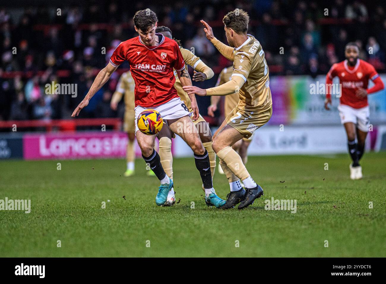 Callum Reynolds of Bromley FC tackles Morecambe FC's Harvey Macadam ...
