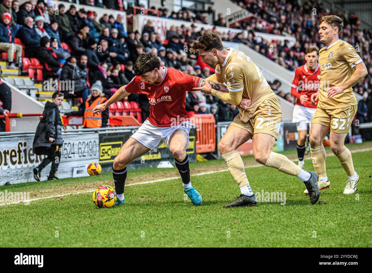 Callum Reynolds of Bromley FC tackles Morecambe FC's Harvey Macadam ...