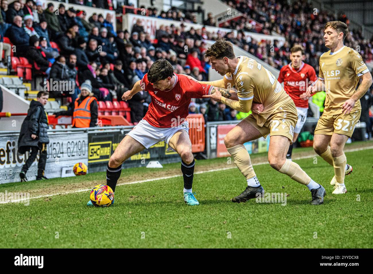 Callum Reynolds of Bromley FC tackles Morecambe FC's Harvey Macadam ...