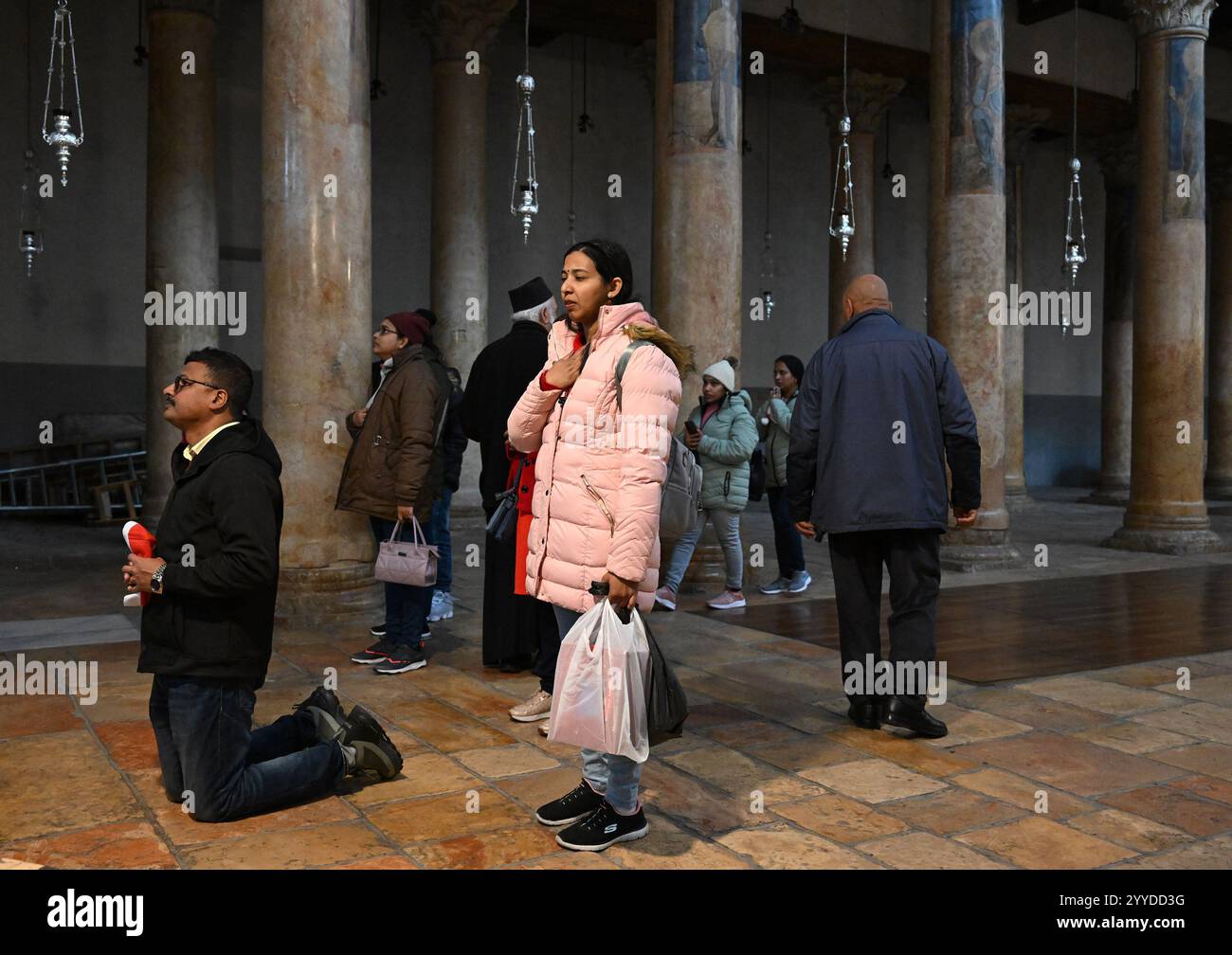 Bethlehem, West Bank. 21st Dec, 2024. A man kneels to pray In the ...