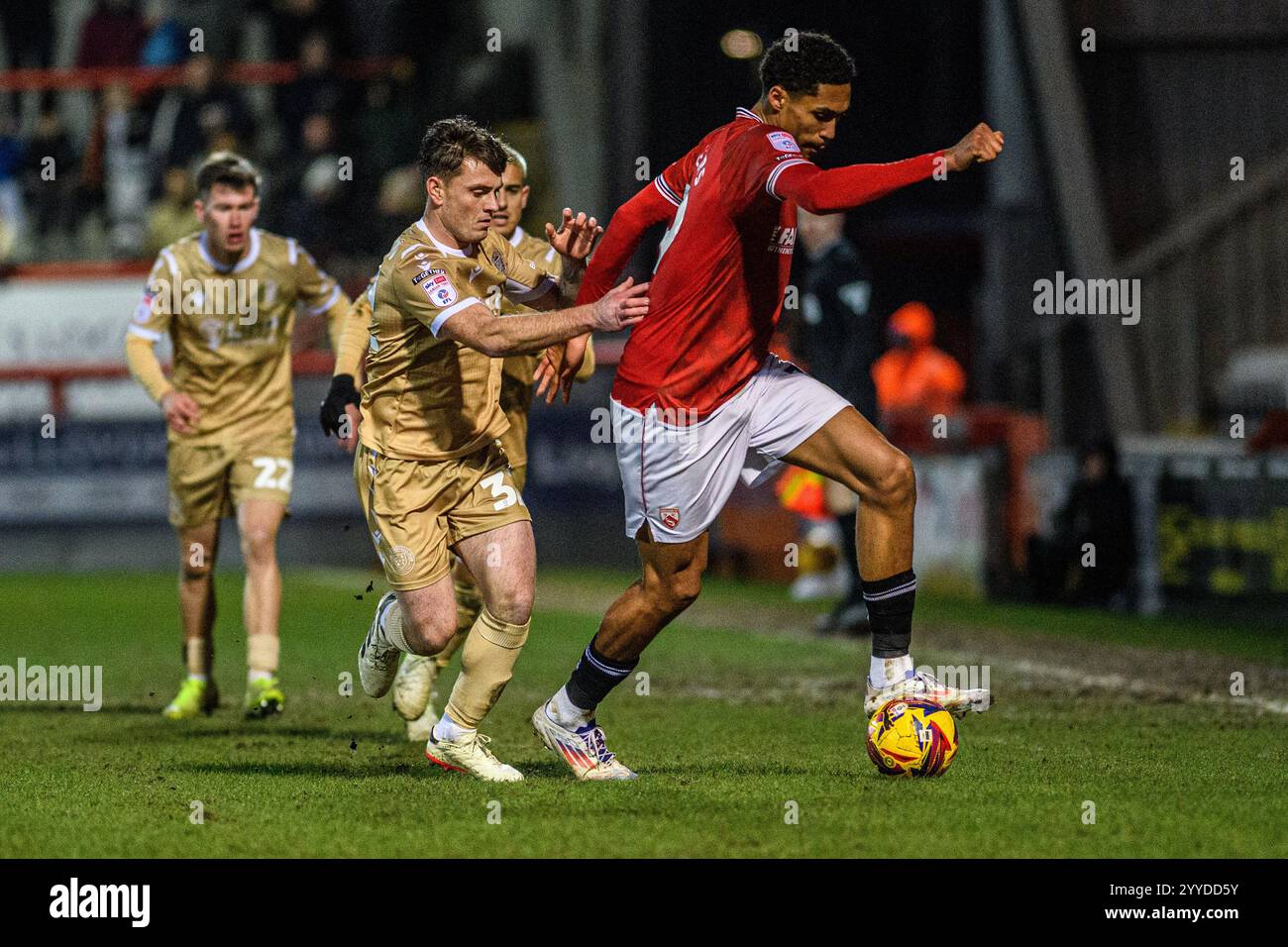 Morecambe FC's Marcus Dackers under pressure fromBen Thompson of ...