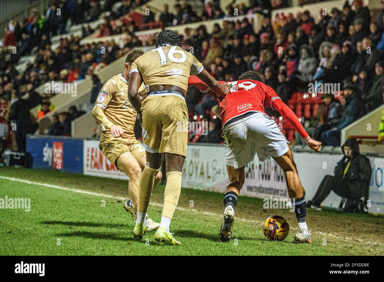 Kamarl Grant of Bromley FC tackles Morecambe FC's Marcus Dackers during ...