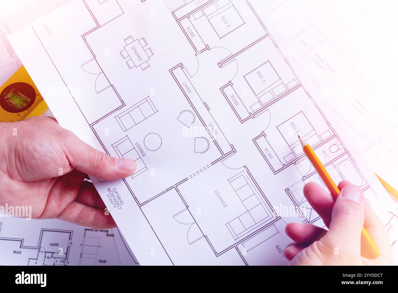 Builder's hands on the background of a house plan. Construction ...