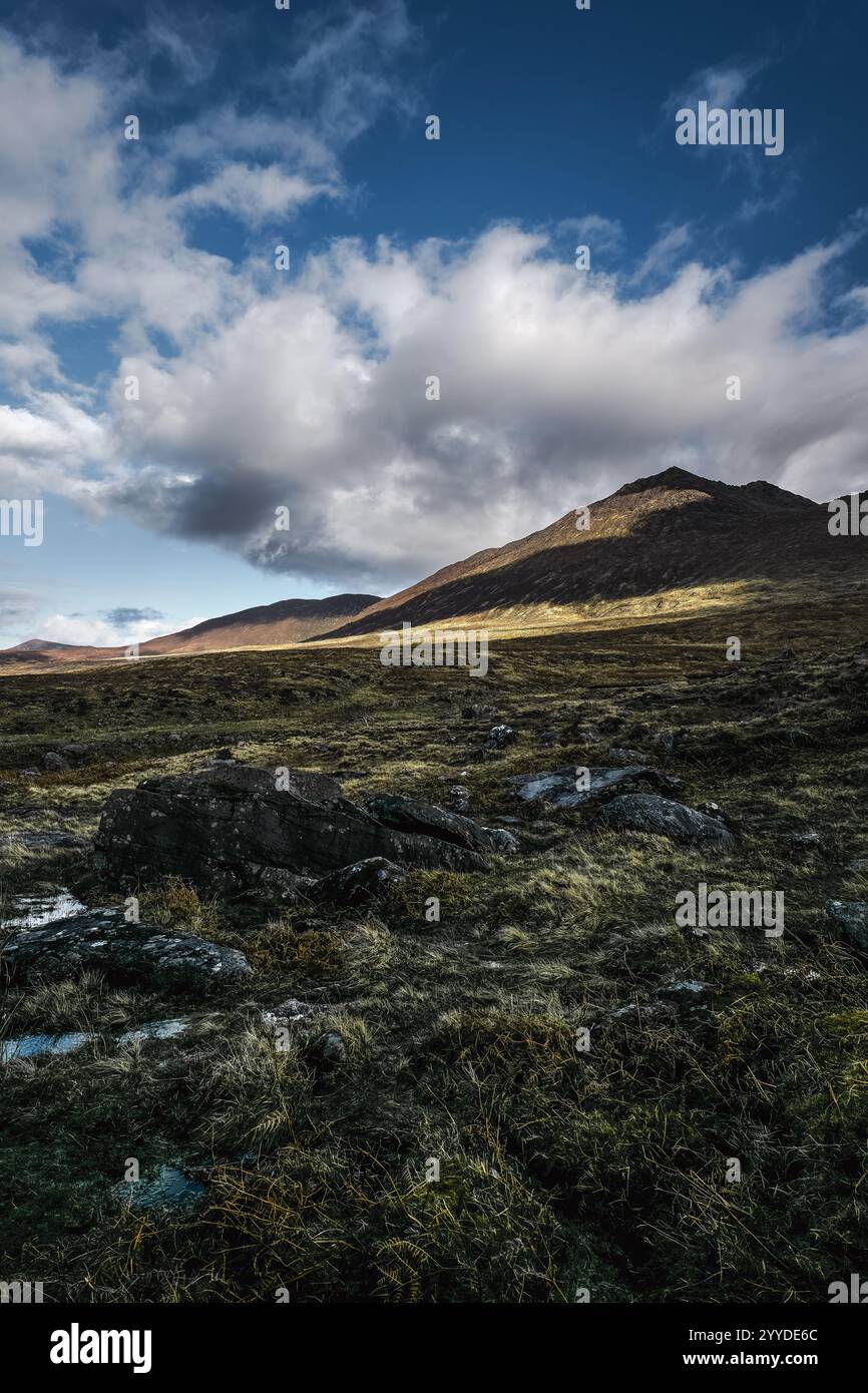 Dramatic landscape of hills under a dynamic sky at dusk in a remote ...