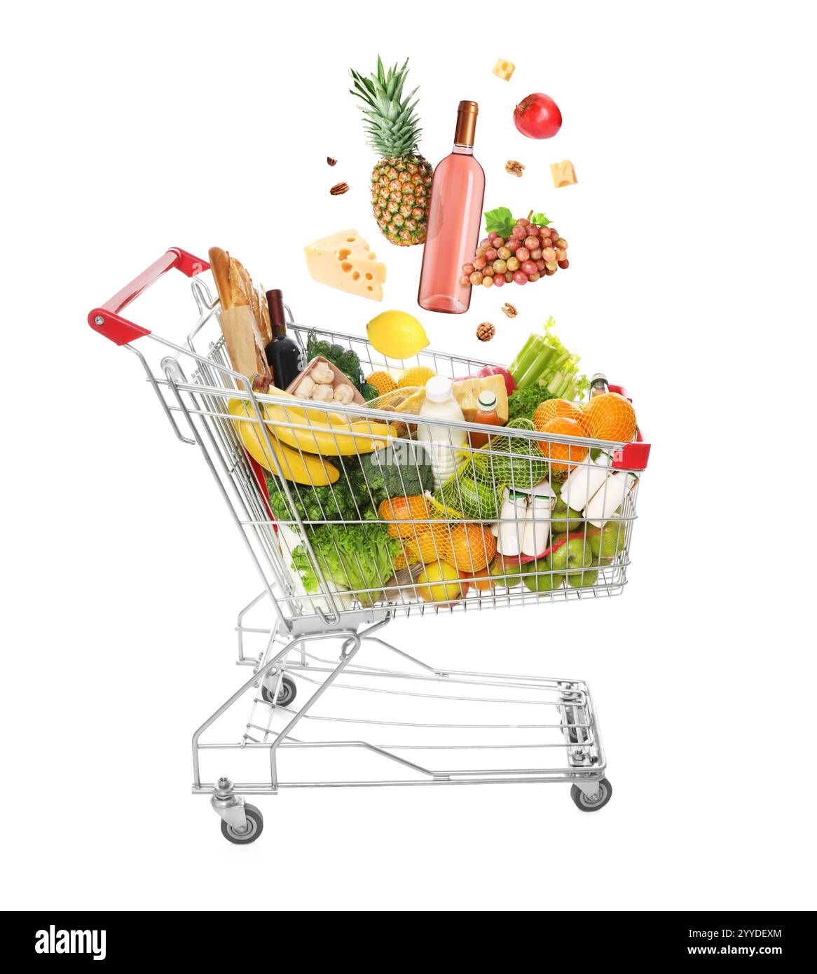 Groceries falling into shopping cart on white background Stock Photo ...