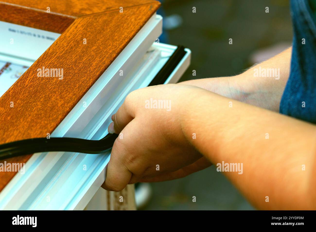 Professional sealing a window frame. Rubber insulation in a plastic ...