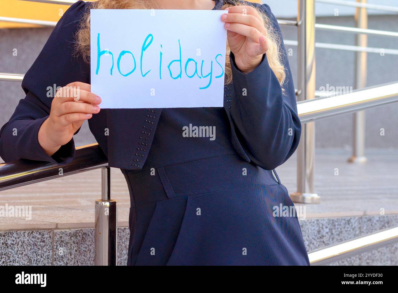 happy girl holding paper with the words holidays. Concept School ...