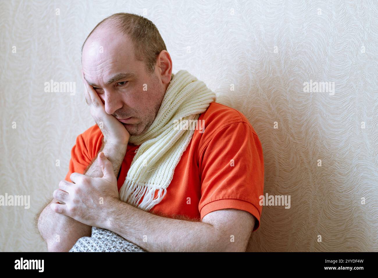 A sick man holds his hand over his head. The patient has a headache ...